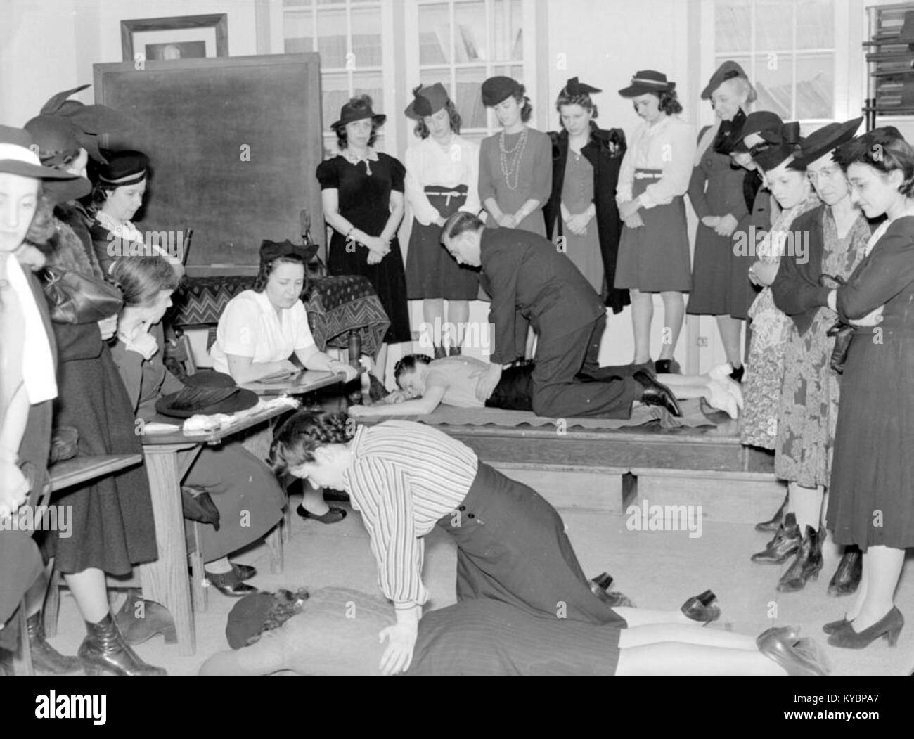 A historical photograph depicting a First Aid class at St-Justine ...