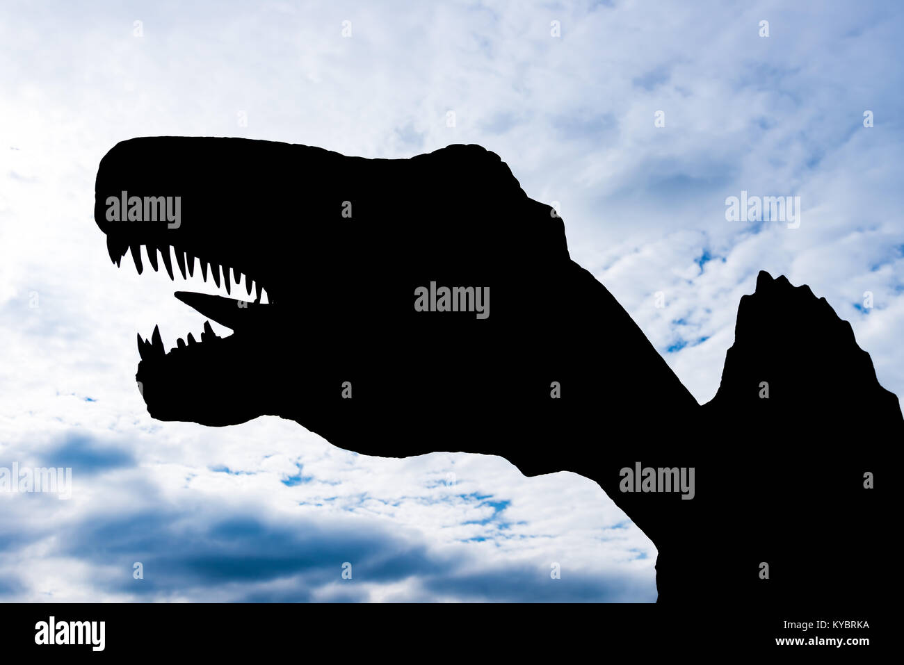 silhouette of a giant size Spinosaurus under blue sky Stock Photo - Alamy