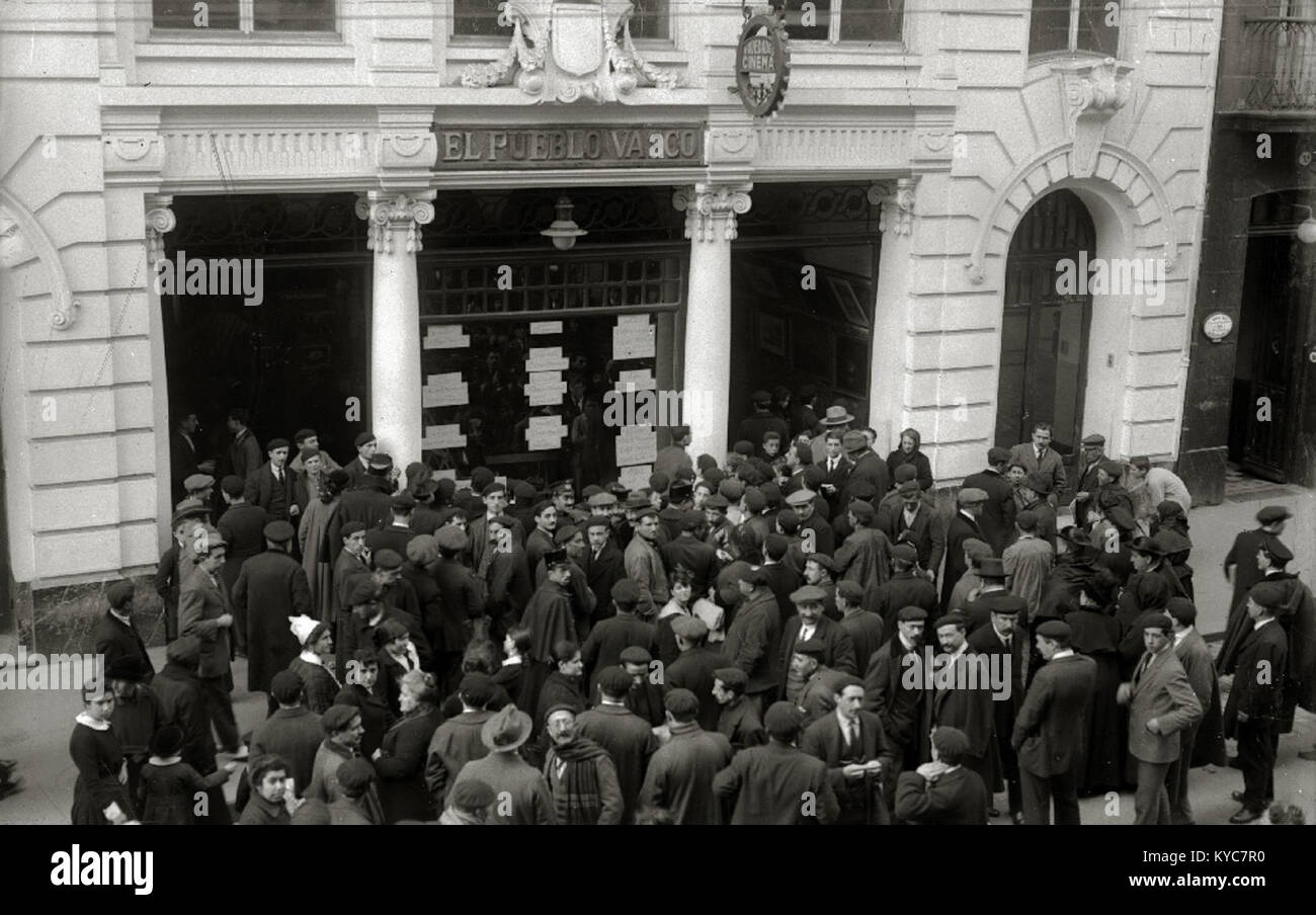 This image shows a crowd gathered outside the editorial office of 'El ...