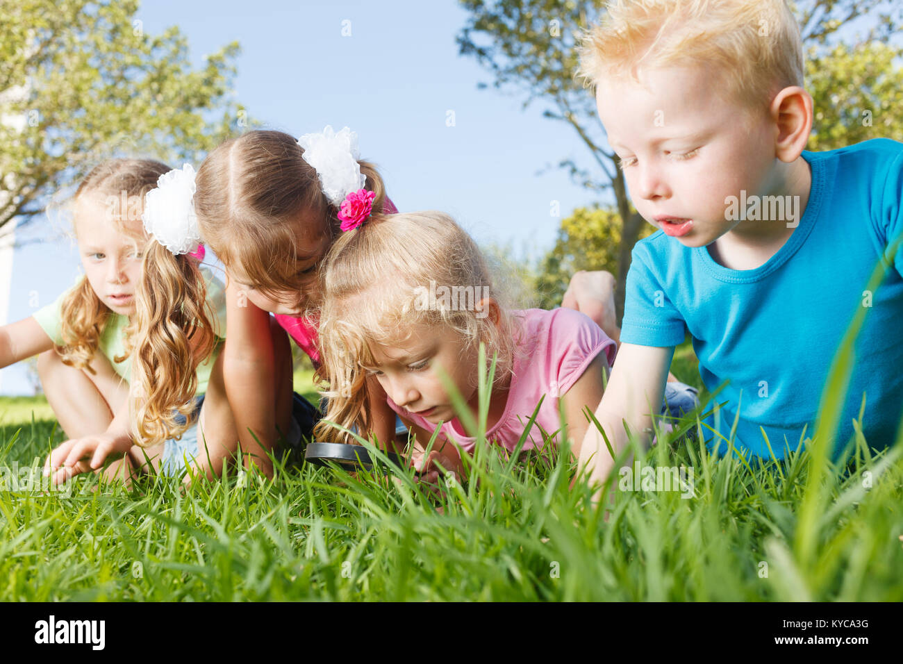 Preschoolers exploring the nature with magnifying glass Stock Photo - Alamy