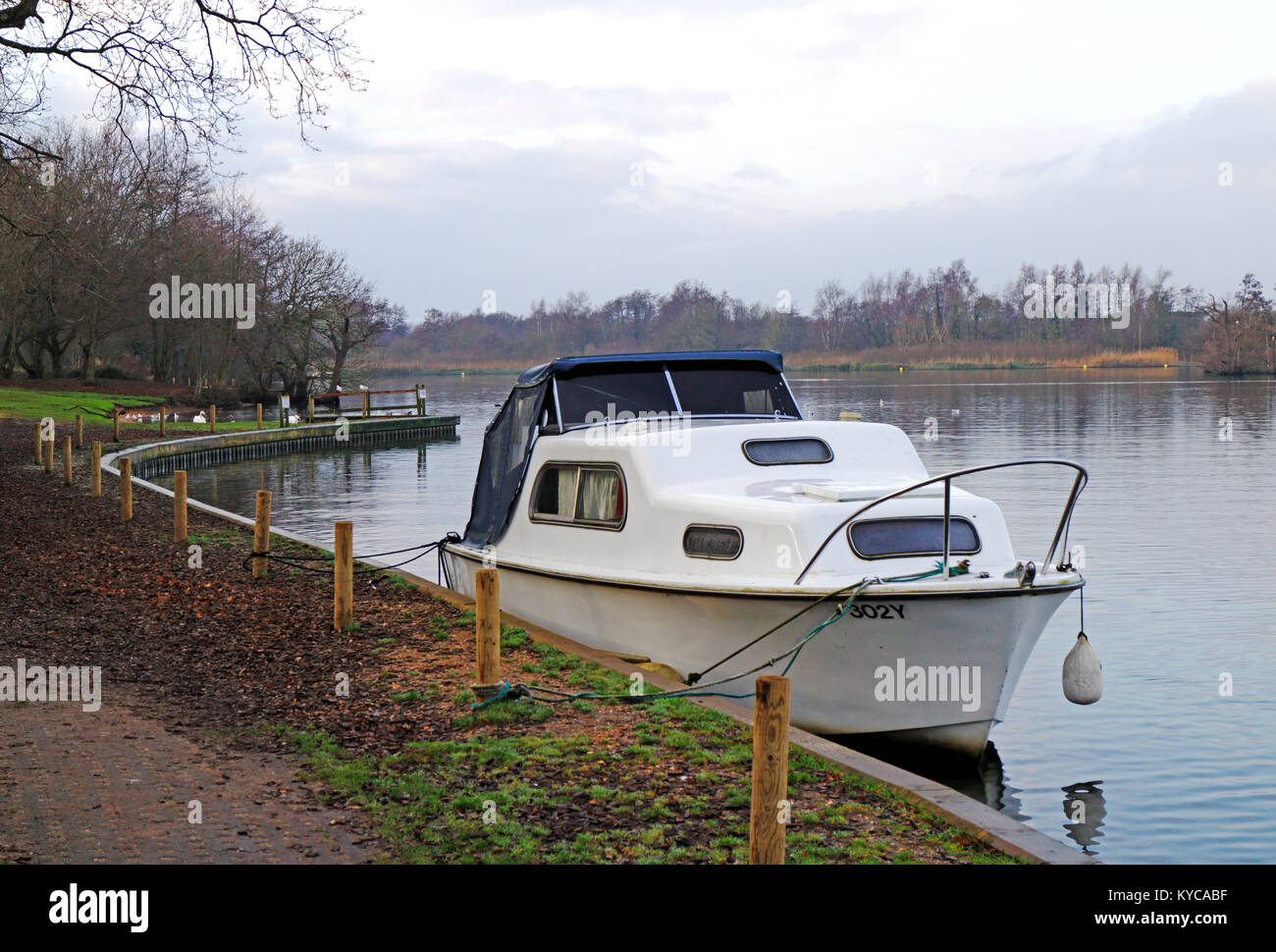 A boat moored at Salhouse Broad on the Norfolk Broads in winter at ...