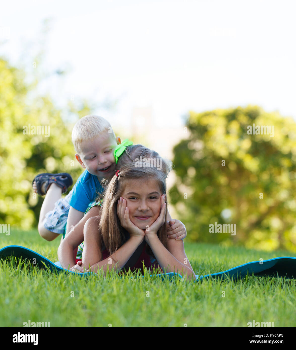 Happy children playing piggy back Stock Photo - Alamy