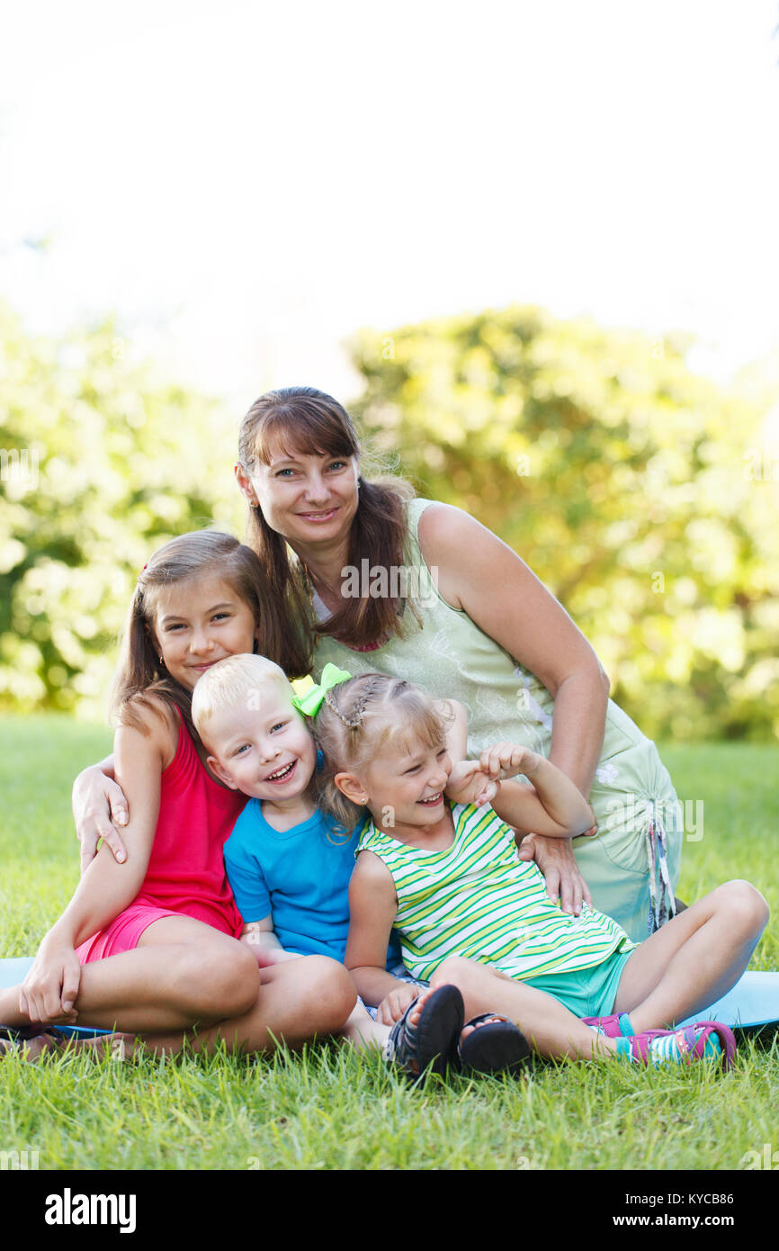 Happy women with her children outside Stock Photo - Alamy