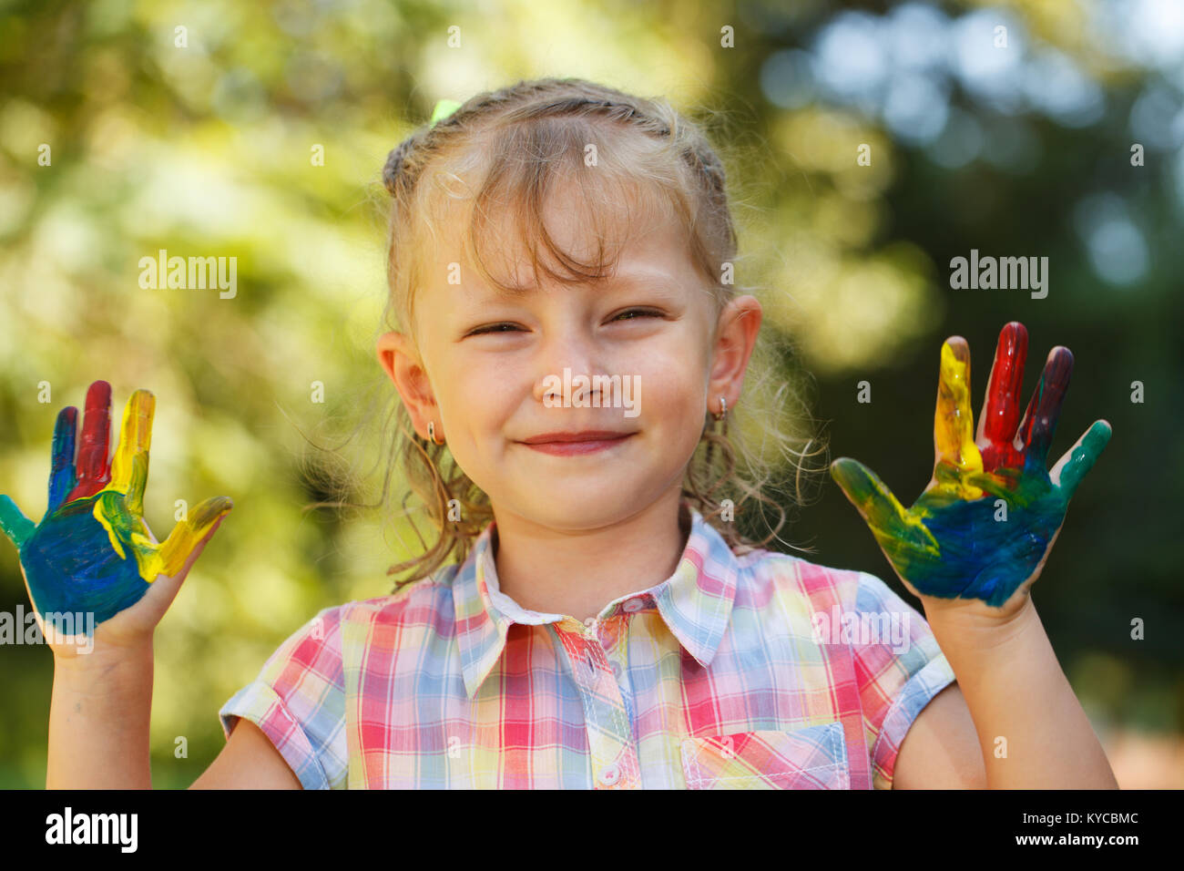 Four year old girl with hands painted in colorful paints ready for hand ...