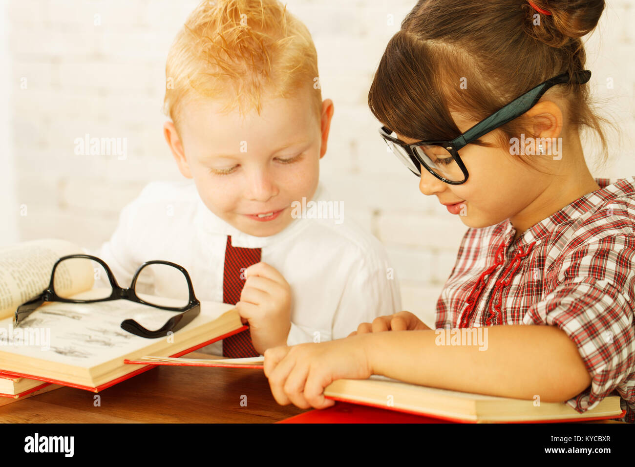 Two cute children nerds are perplexed and thinking Stock Photo - Alamy