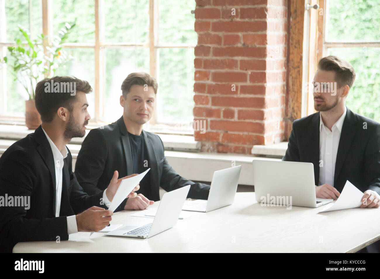 Businessman suit talking group three hi-res stock photography and ...