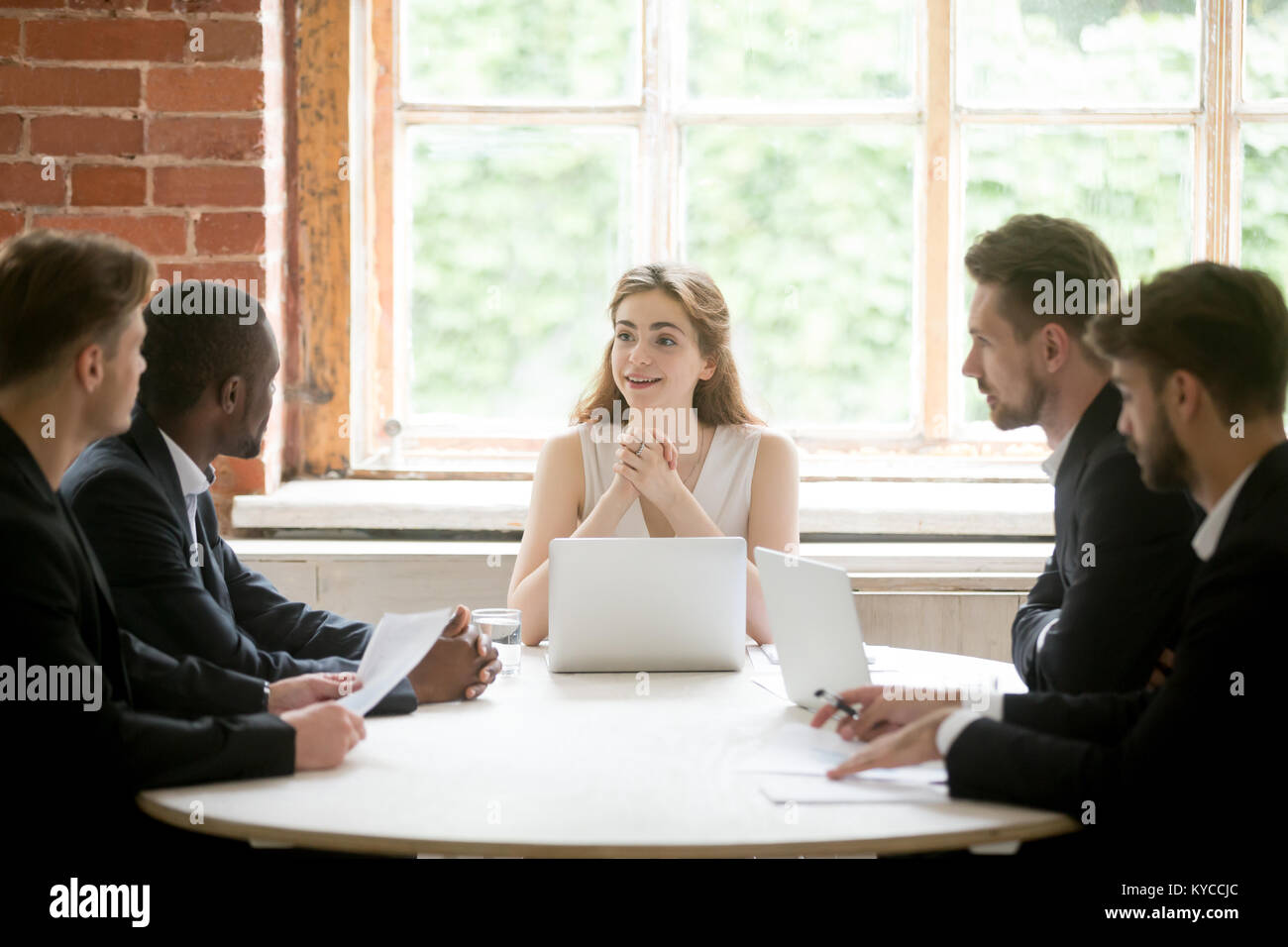 Friendly female boss holding office corporate meeting with diverse ...