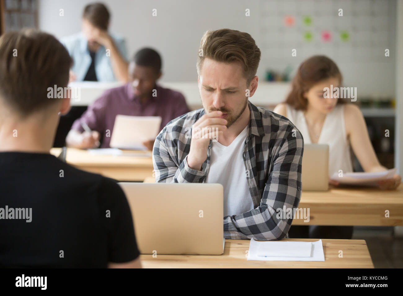 Frustrated businessman thinking solving problem working on laptop in co ...