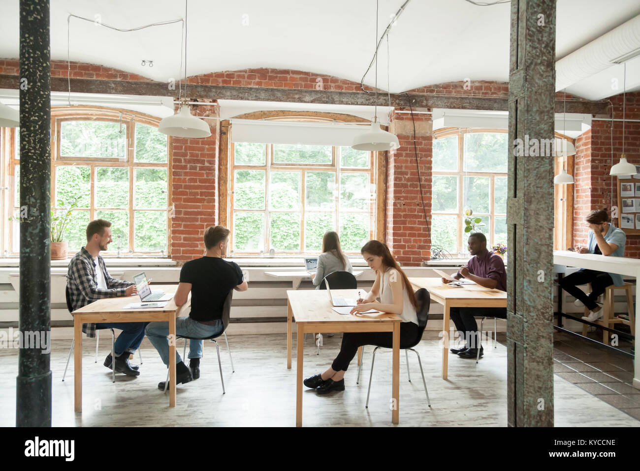 Multiracial people work in modern co-working center interior, diverse ...