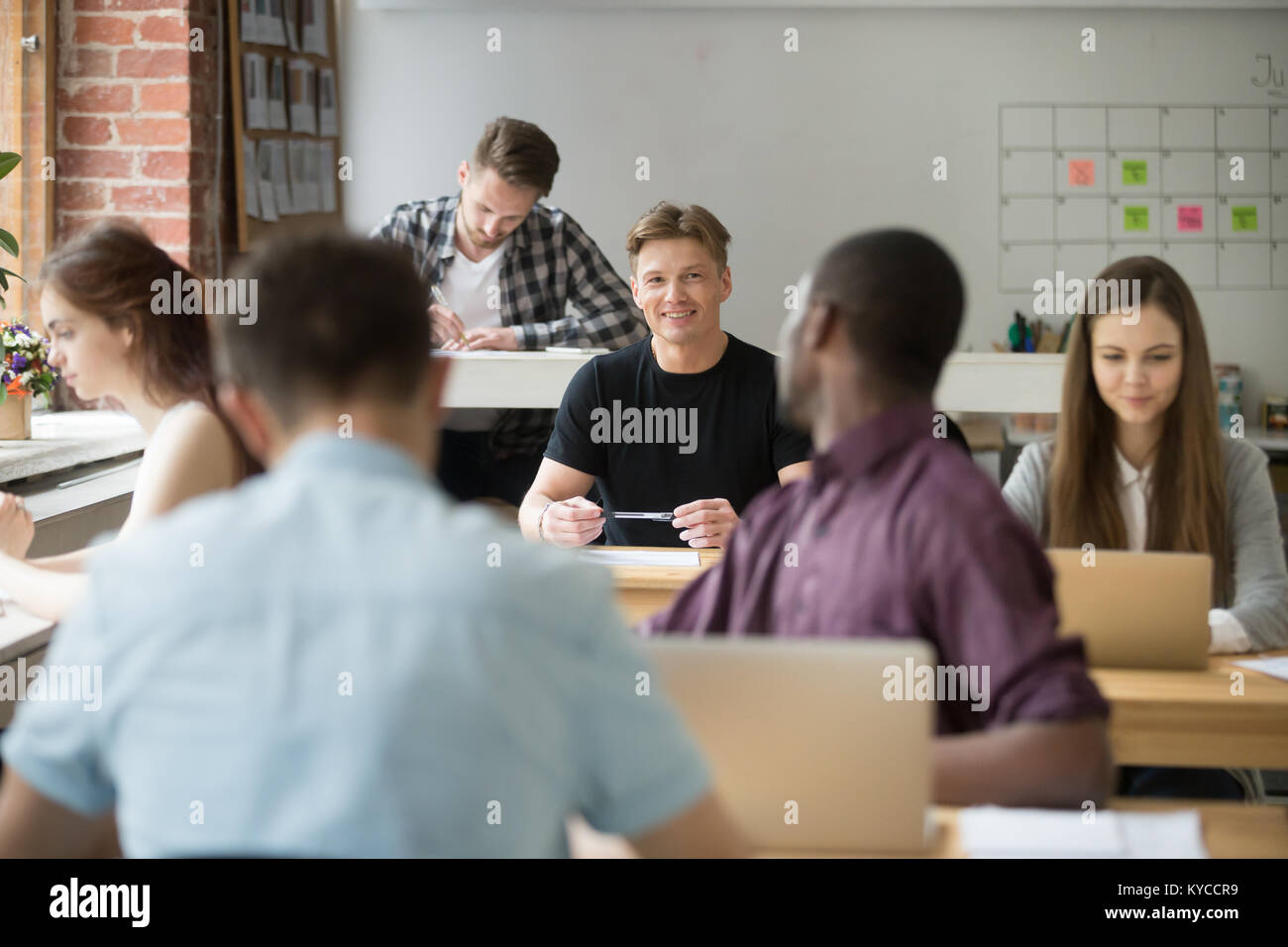 African-american and caucasian colleagues talking at work in coworking ...