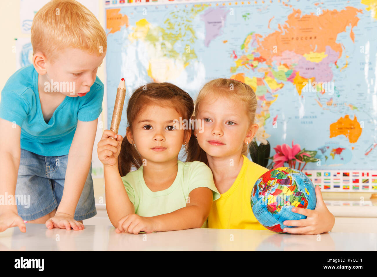 Three preschoolers in the classroom Stock Photo - Alamy