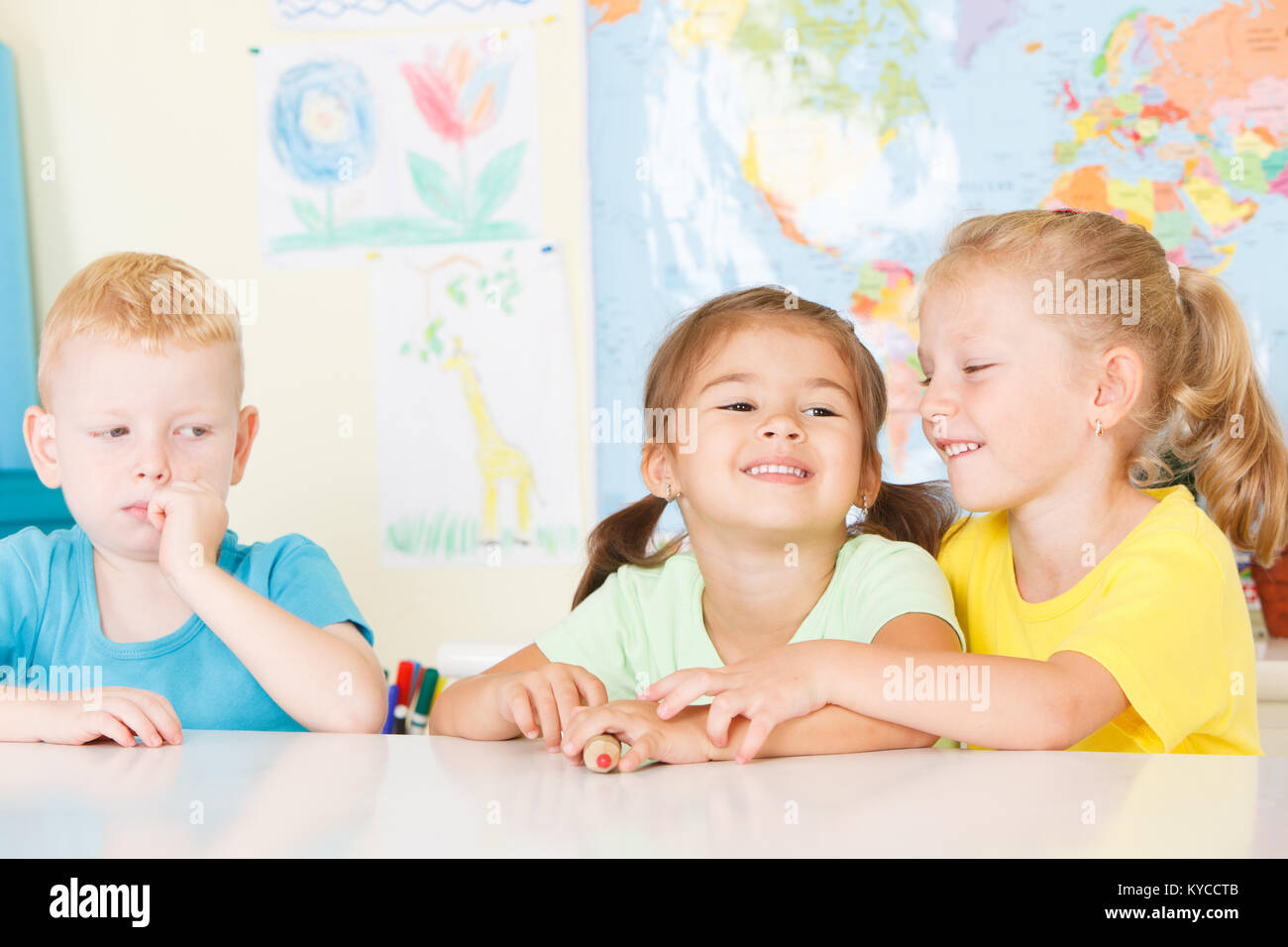 Three preschoolers in the classroom Stock Photo - Alamy