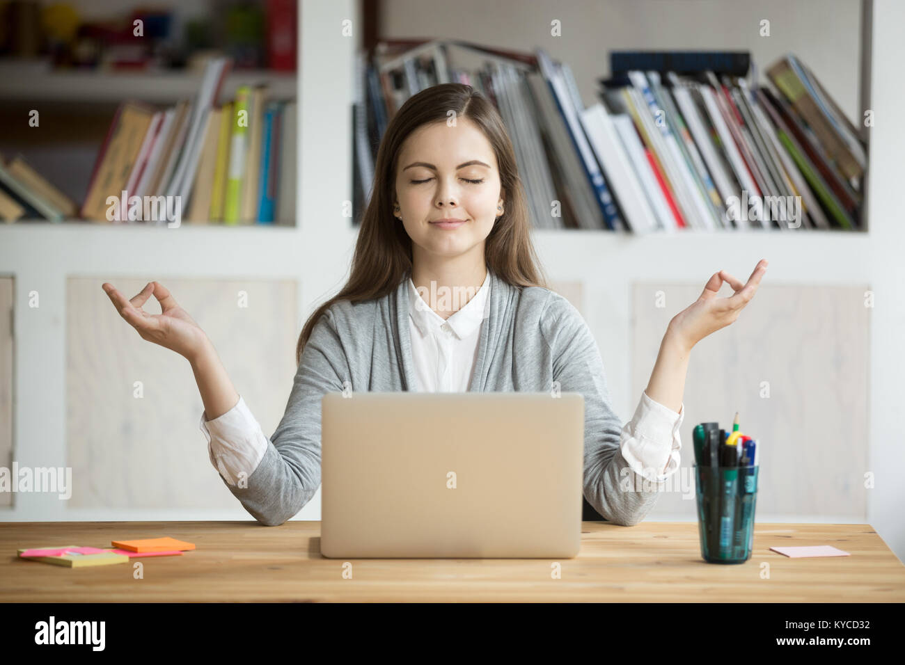Calm woman relaxing meditating with laptop, no stress free relief at ...