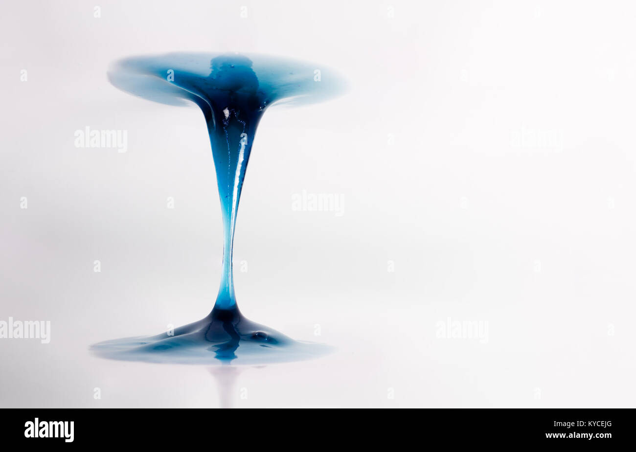 The viscous substance in the form of a colored gel is stretched between ...