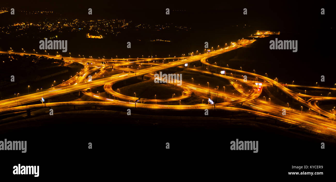 Aerial view of highway crossroad at night. Traffic and transportation ...