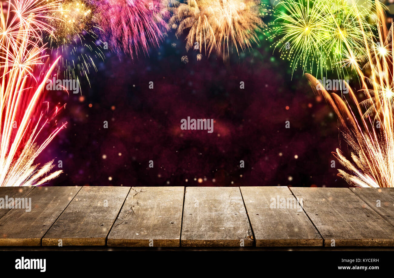 Celebration background with fireworks explosions and empty wooden ...