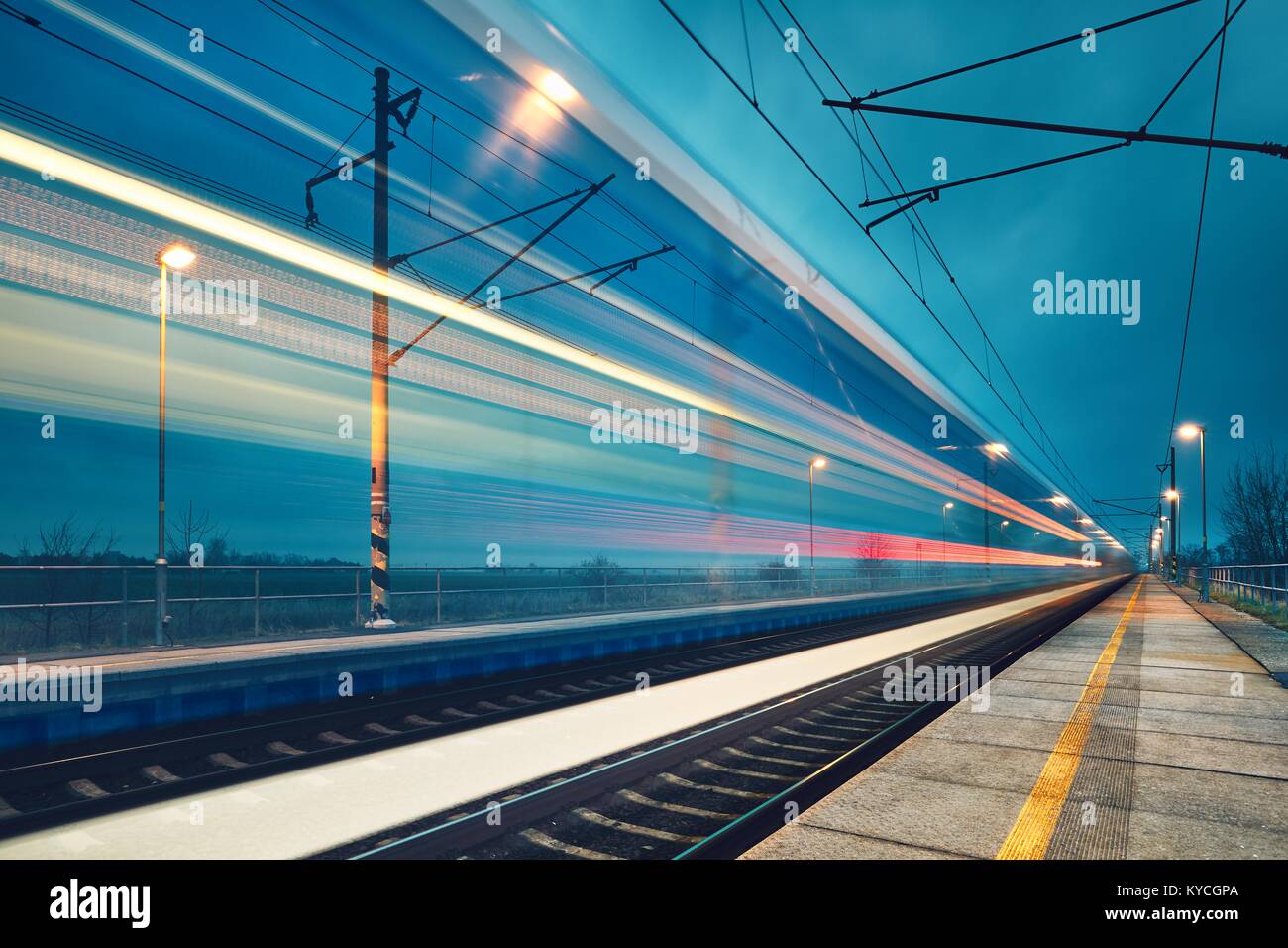 Light trail of the express train in the railway station at the night ...