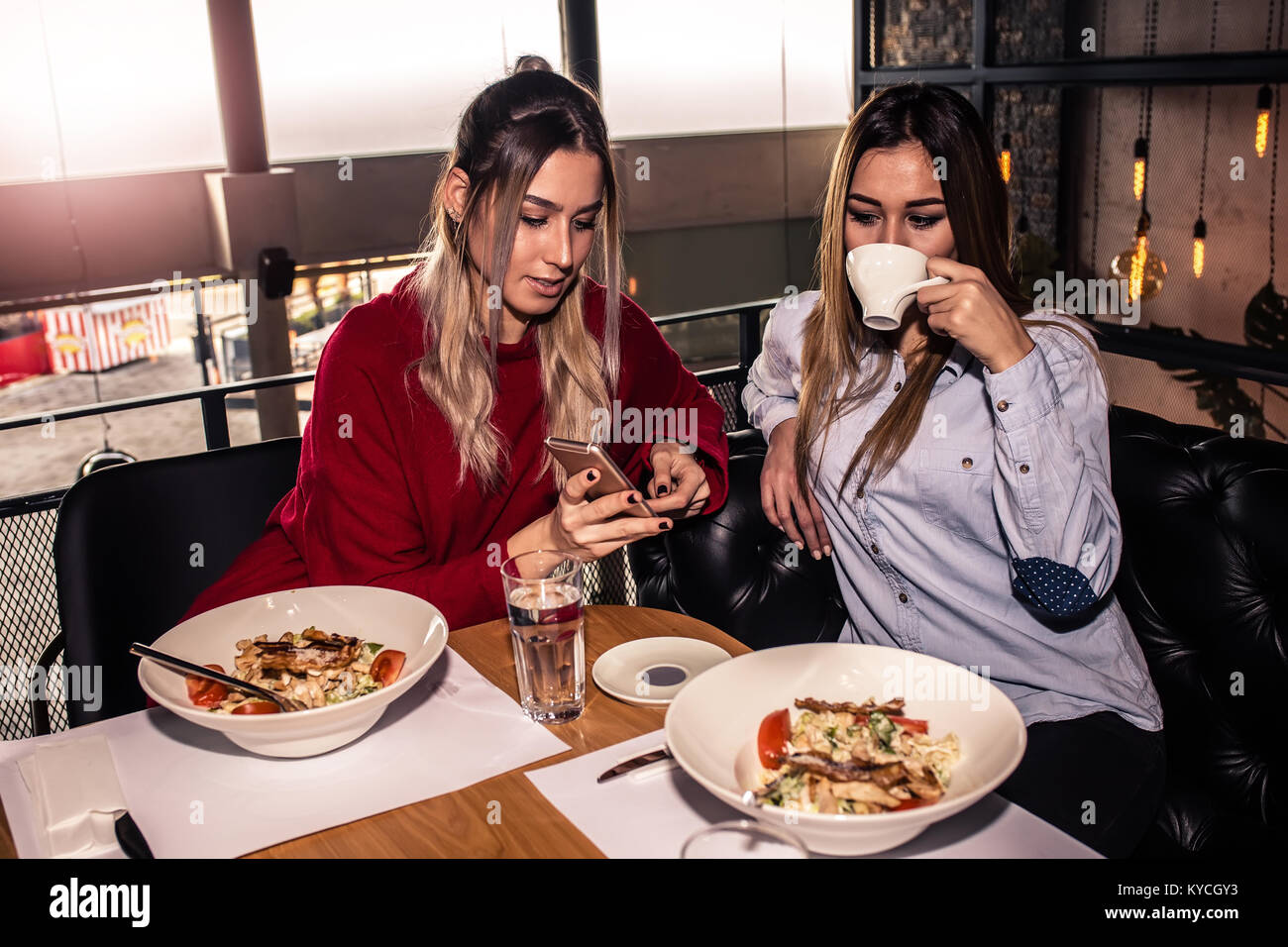 Female Friends Having Lunch Together At The Restaurant. Two young women ...