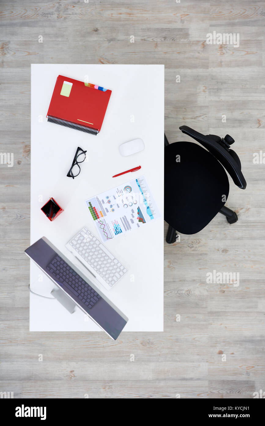 Directly above view of office desktop with modern computer, folder ...