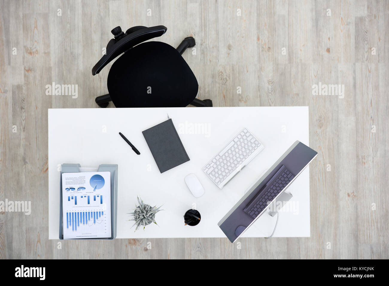 Interior of modern office: swivel chair and desk with notepad ...