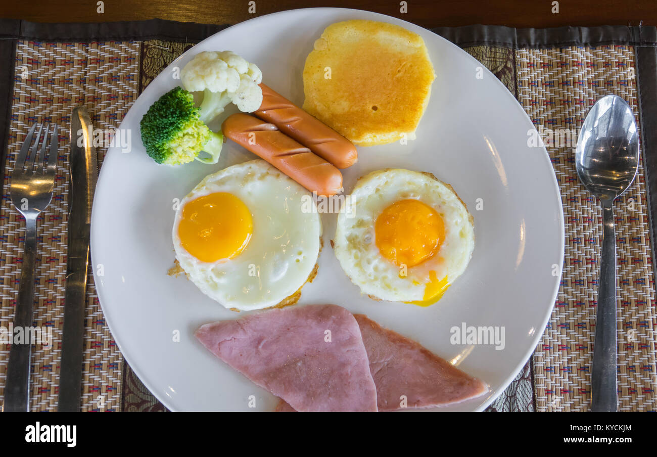American breakfast with sunny side up eggs, bacon, toast, pancakes ...