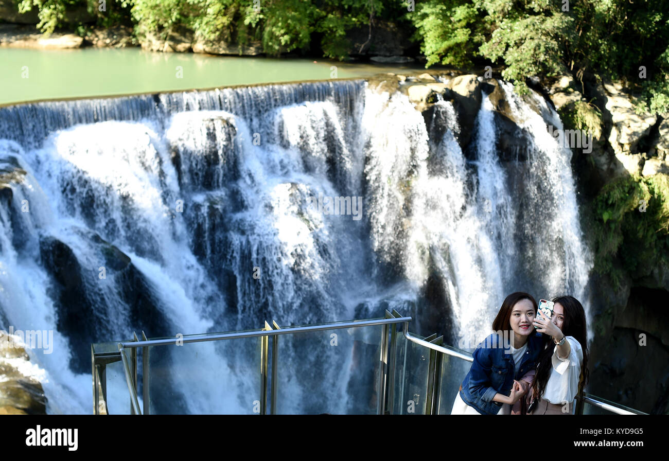Taibei, China's Taiwan. 14th Jan, 2018. Tourists pose for a photo at ...