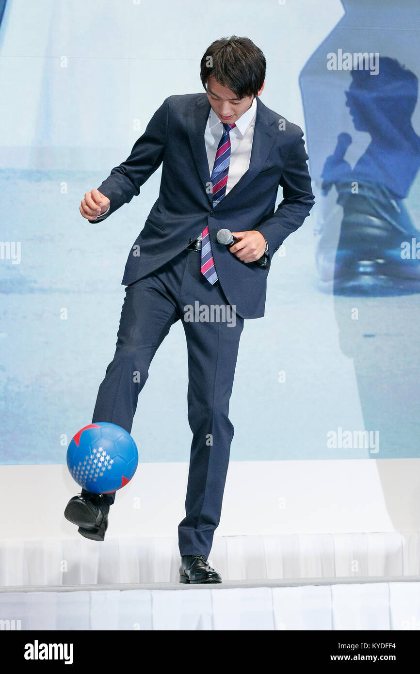 Japanese actor Ryoma Takeuchi shows his soccer skills during a news ...