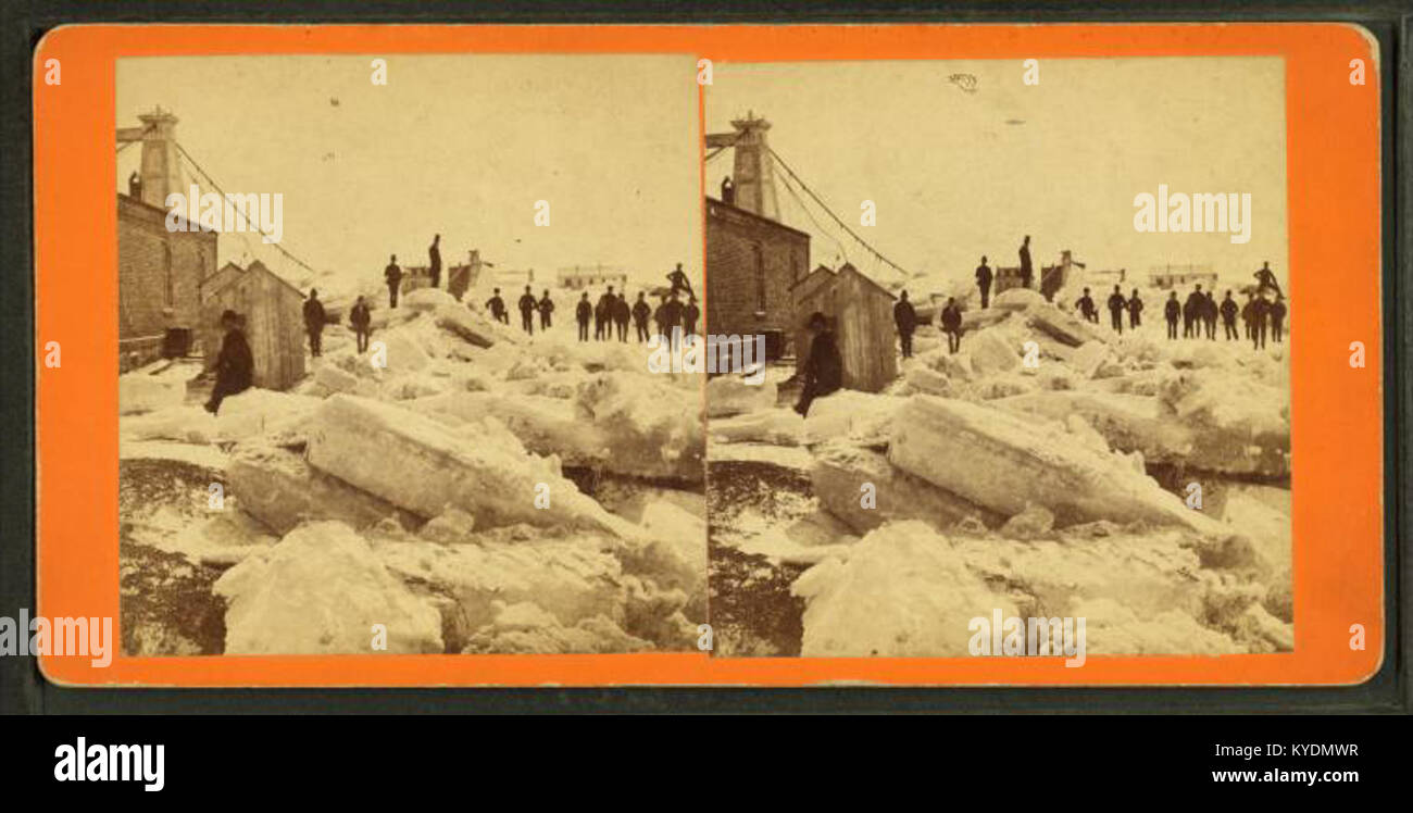 A historical photograph by Masterson & Wood showing a suspension bridge ...