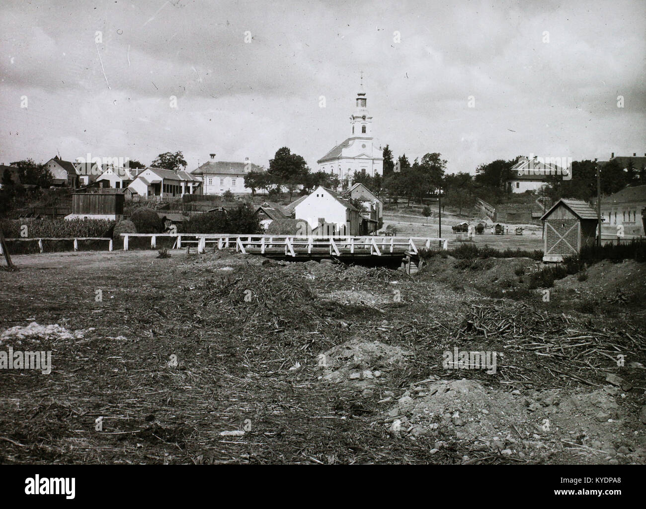 A historical photograph depicting a Catholic church with its parsonage ...