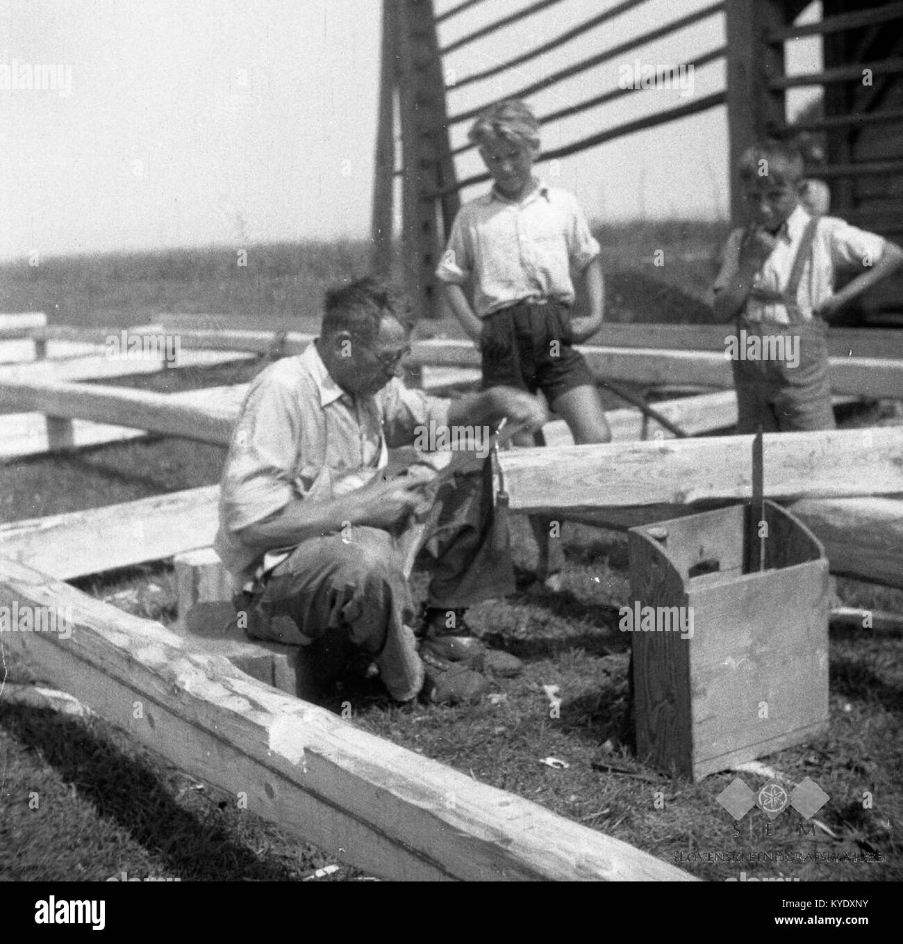 This Slovenian image depicts a blacksmith sitting at his workbench ...