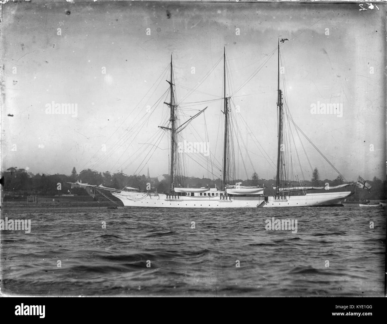 A photograph of a three-masted sailing vessel on Sydney Harbour, with ...