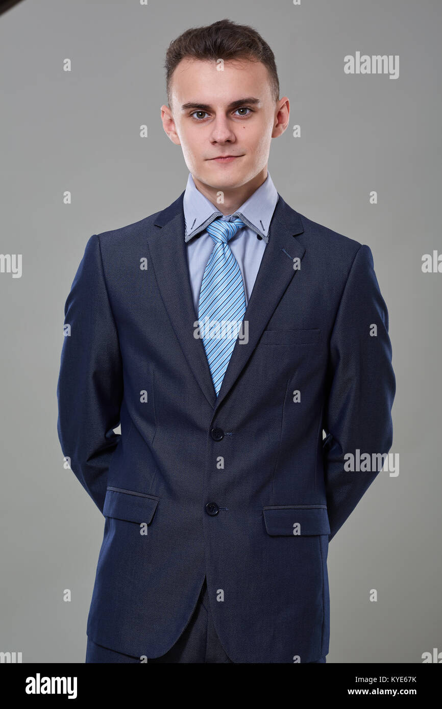 Young man in classic business suit, studio portrait Stock Photo - Alamy