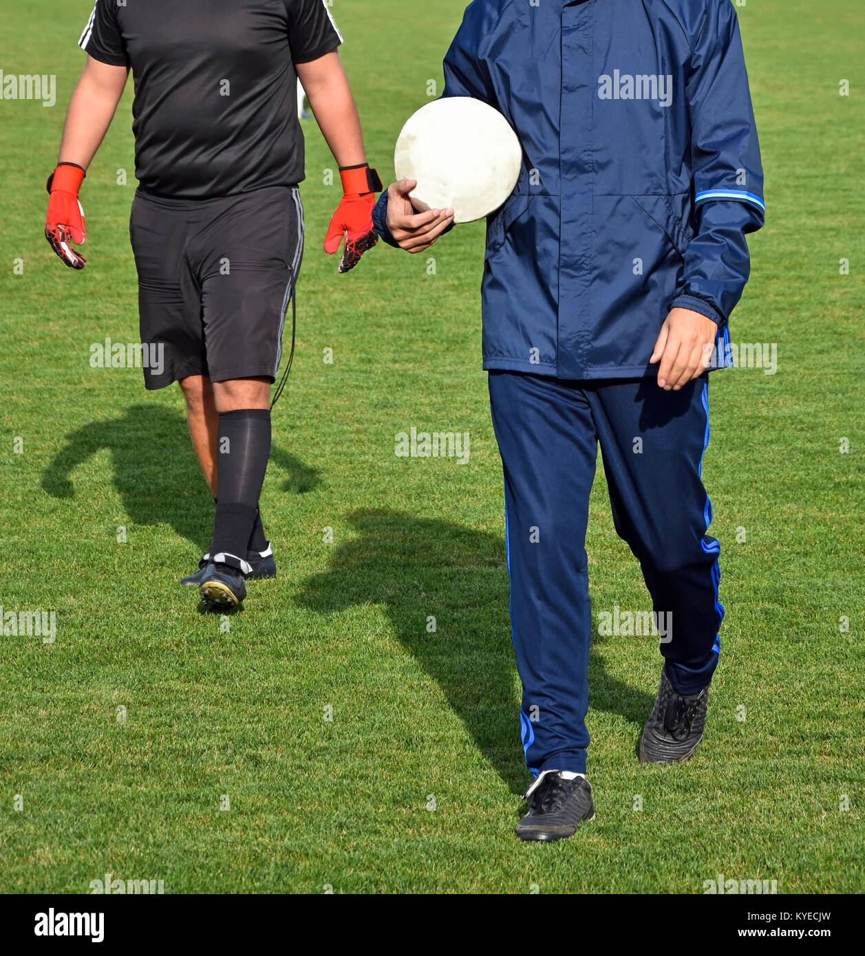 Coach and goalkeeper on the soccer field Stock Photo - Alamy