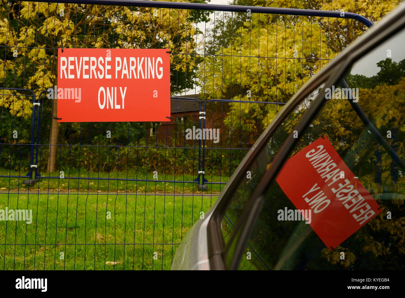 Reverse parking only sign on a car park fence Stock Photo - Alamy