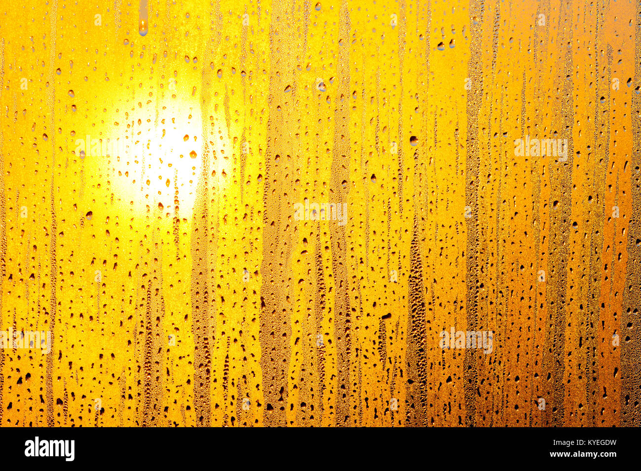 The bright sun through the glass window. Sunrise in yellow red tawny ...