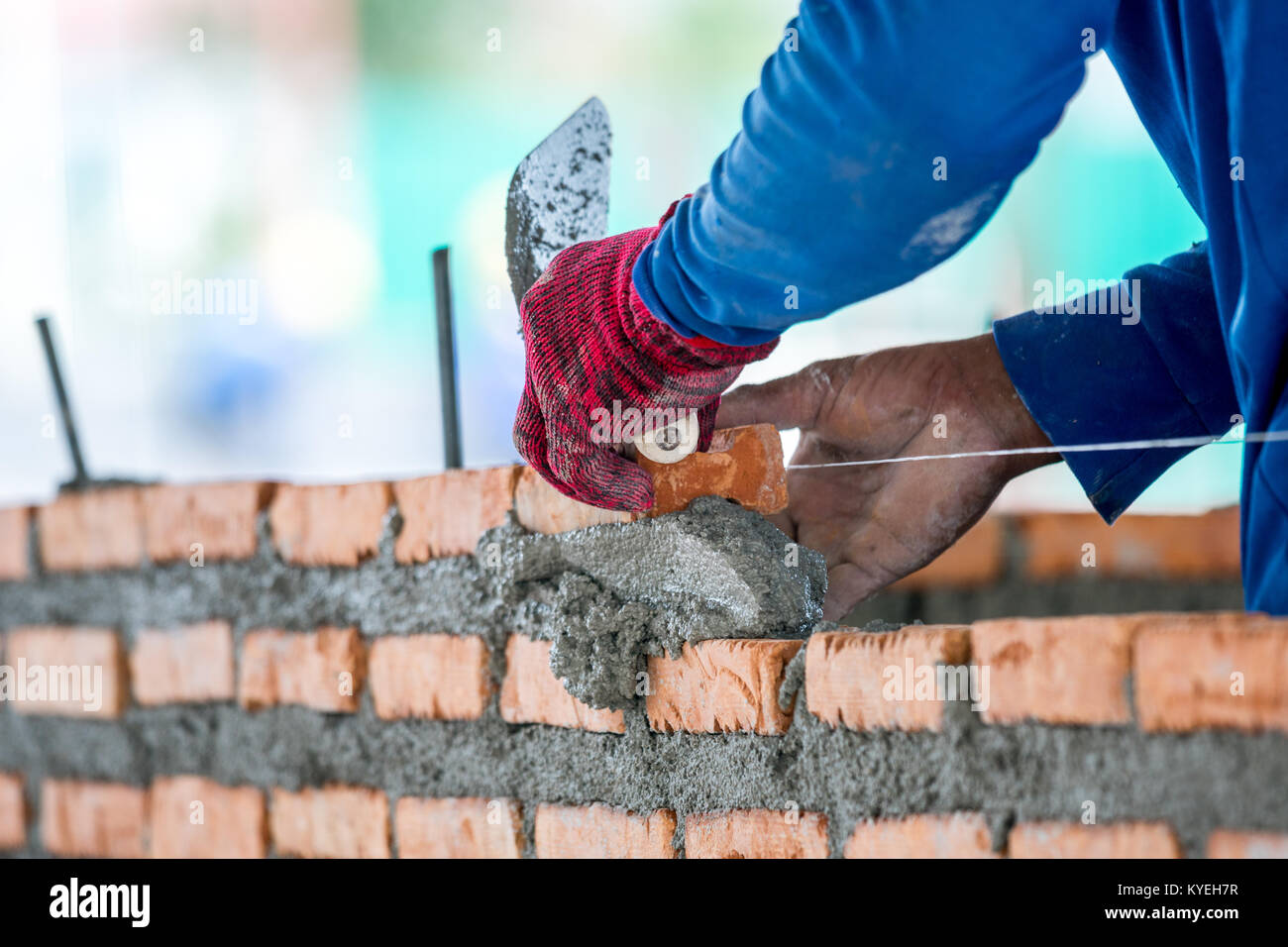 construction worker laying bricks and building in construction site ...