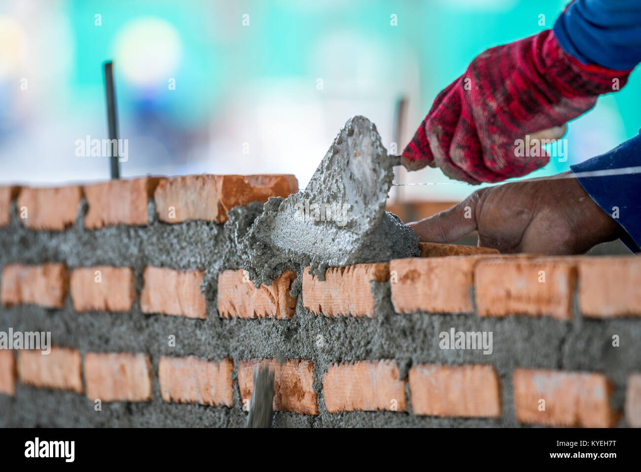 construction worker laying bricks and building in construction site ...