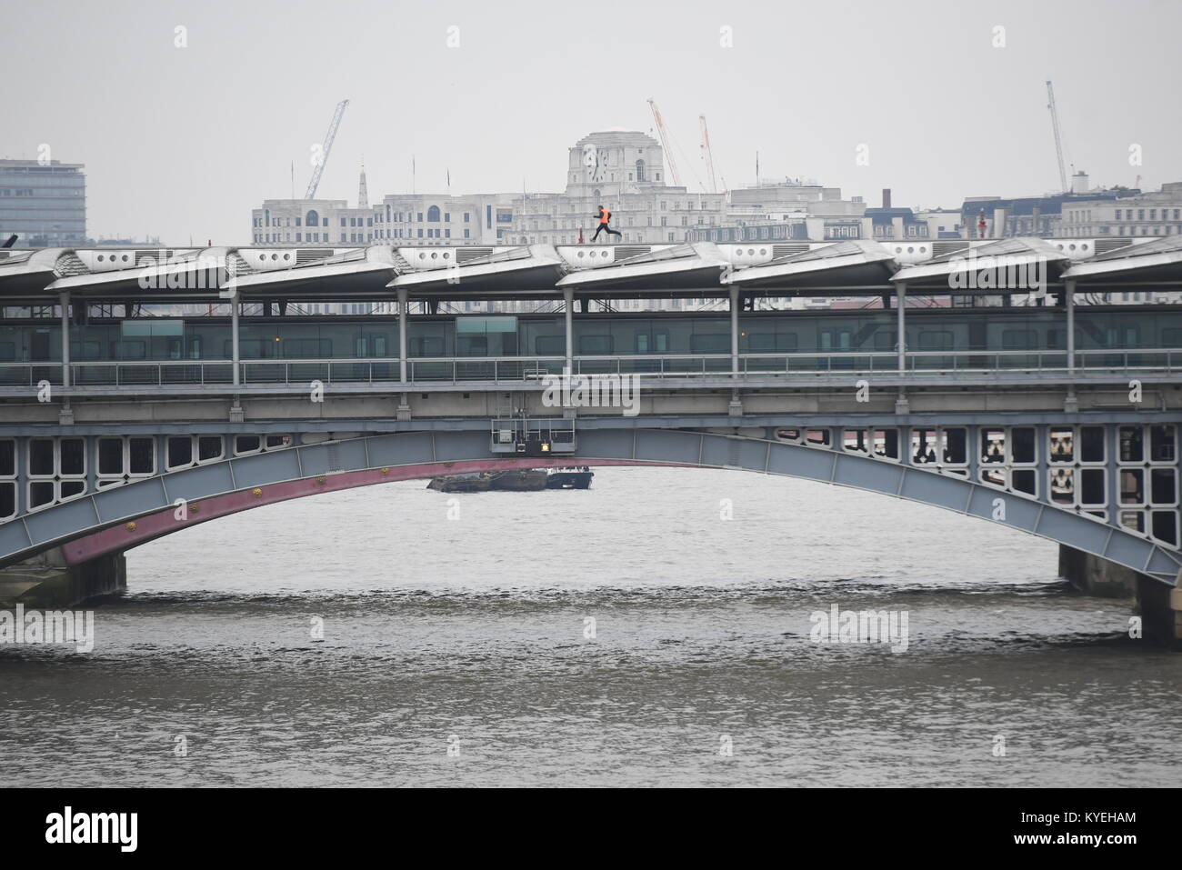 A stunt double runs along Blackfriars Bridge in London, during filming ...