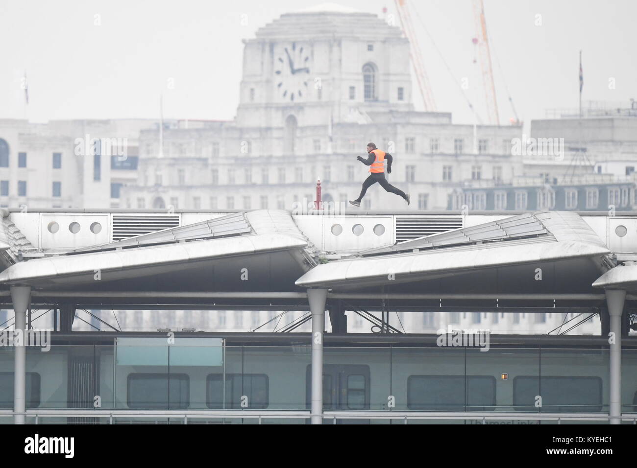 A stunt double runs along Blackfriars Bridge in London, during filming ...