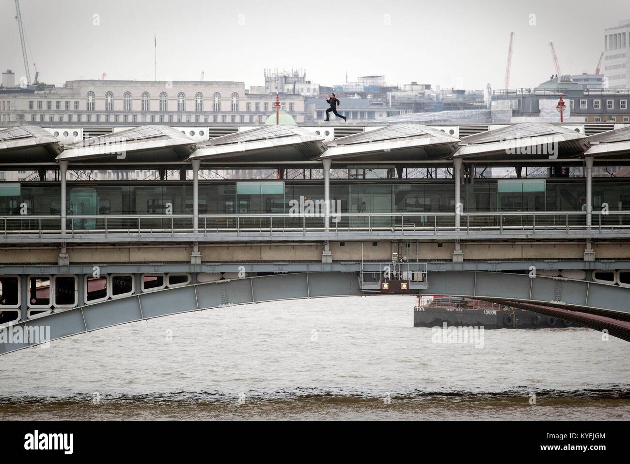 Tom Cruise runs along Blackfriars Bridge in London, during filming for ...