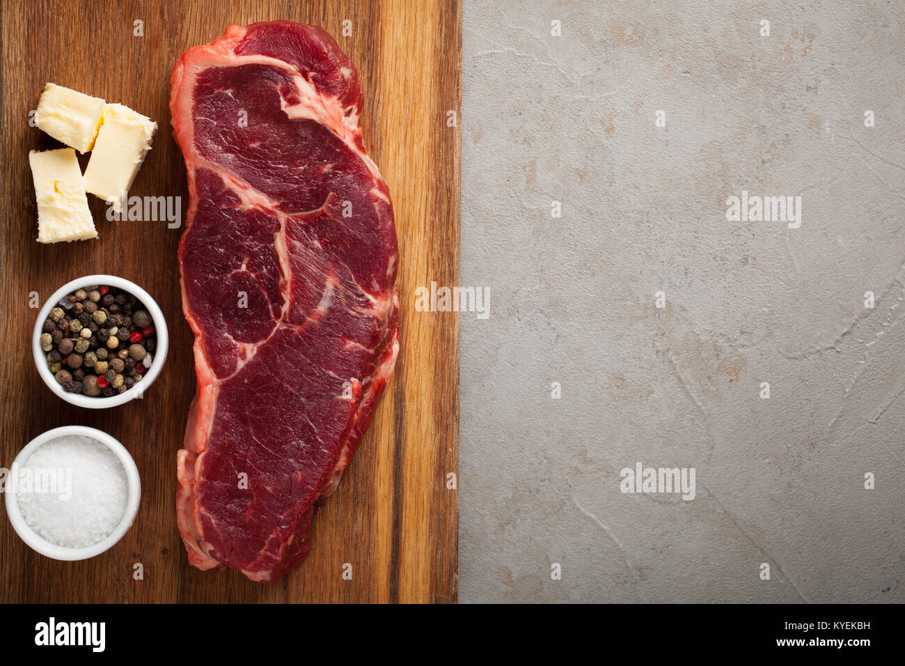 Raw beef marbled steak with vintage white Cutlery on old stone ...