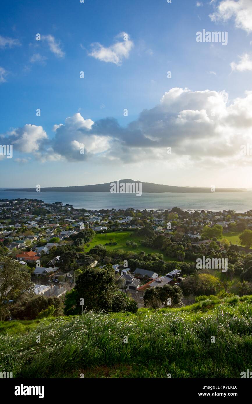 Rangitoto island is visible in the distance, under a brilliant sunrise ...