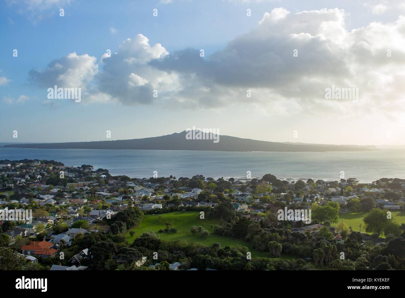 Rangitoto island is visible in the distance, under a brilliant sunrise ...