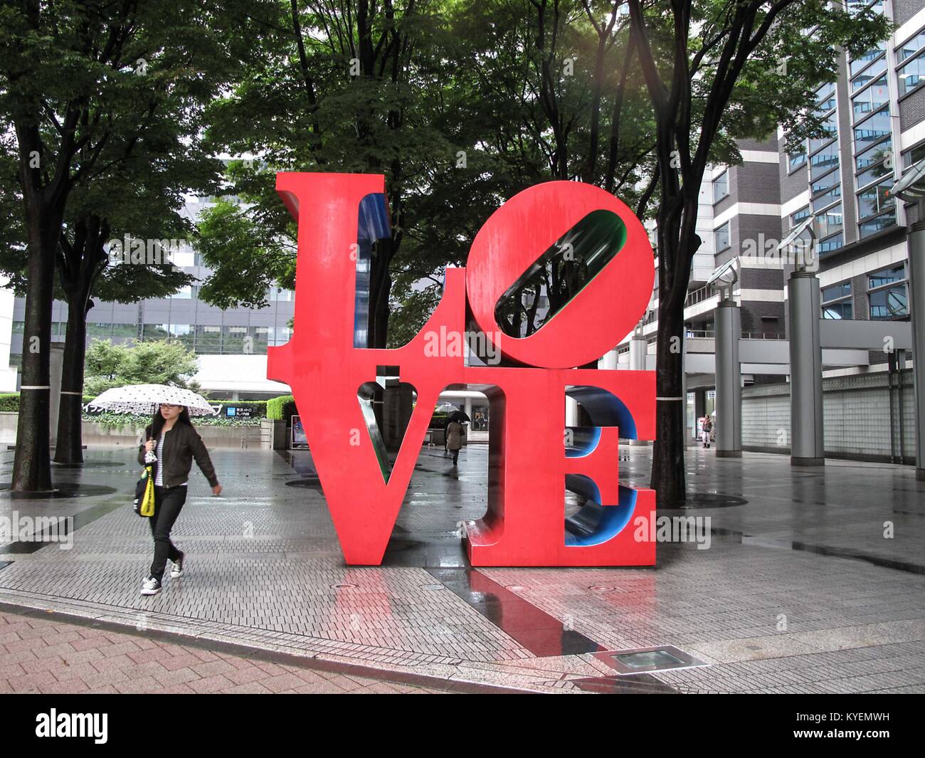 A woman walks past the LOVE statue, a popular tourist attraction in the ...