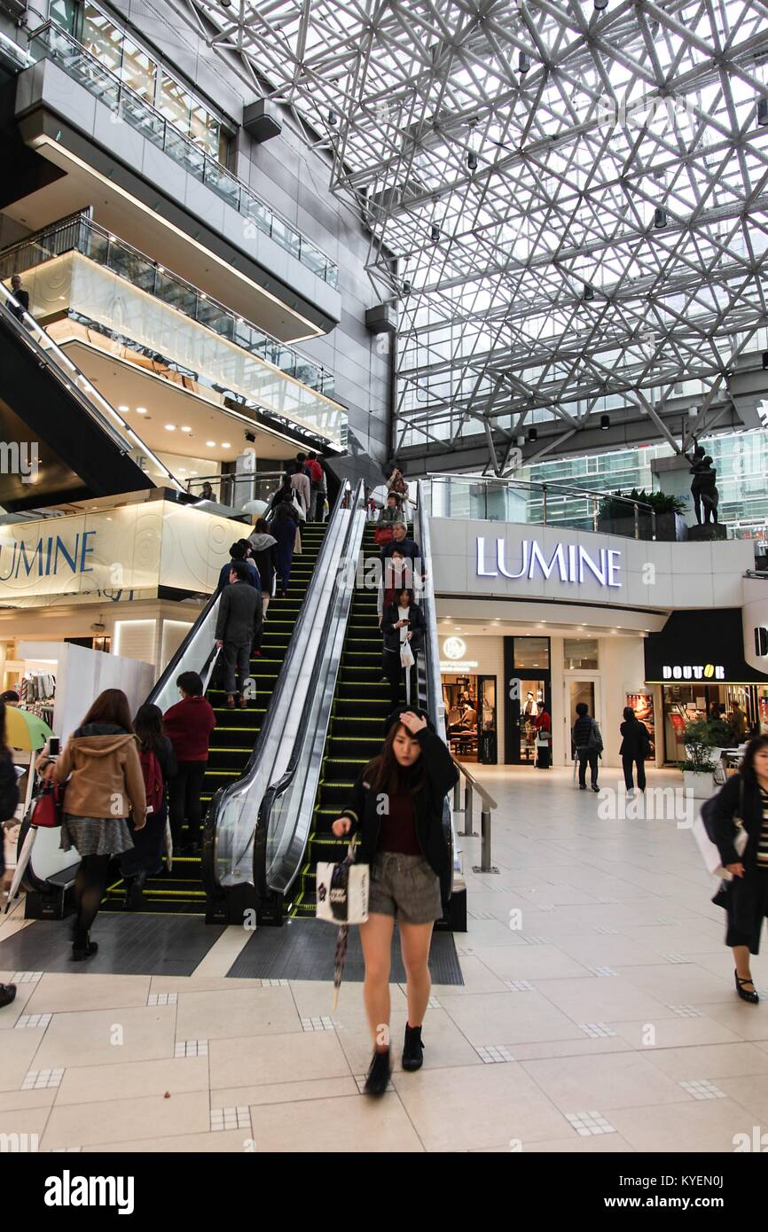 People enter and exit elevators at an indoor shopping mall in the ...