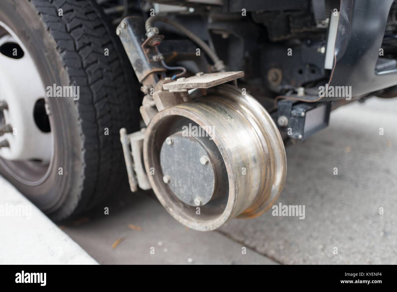 Close-up of converted railroad wheels on the front of a road-rail ...