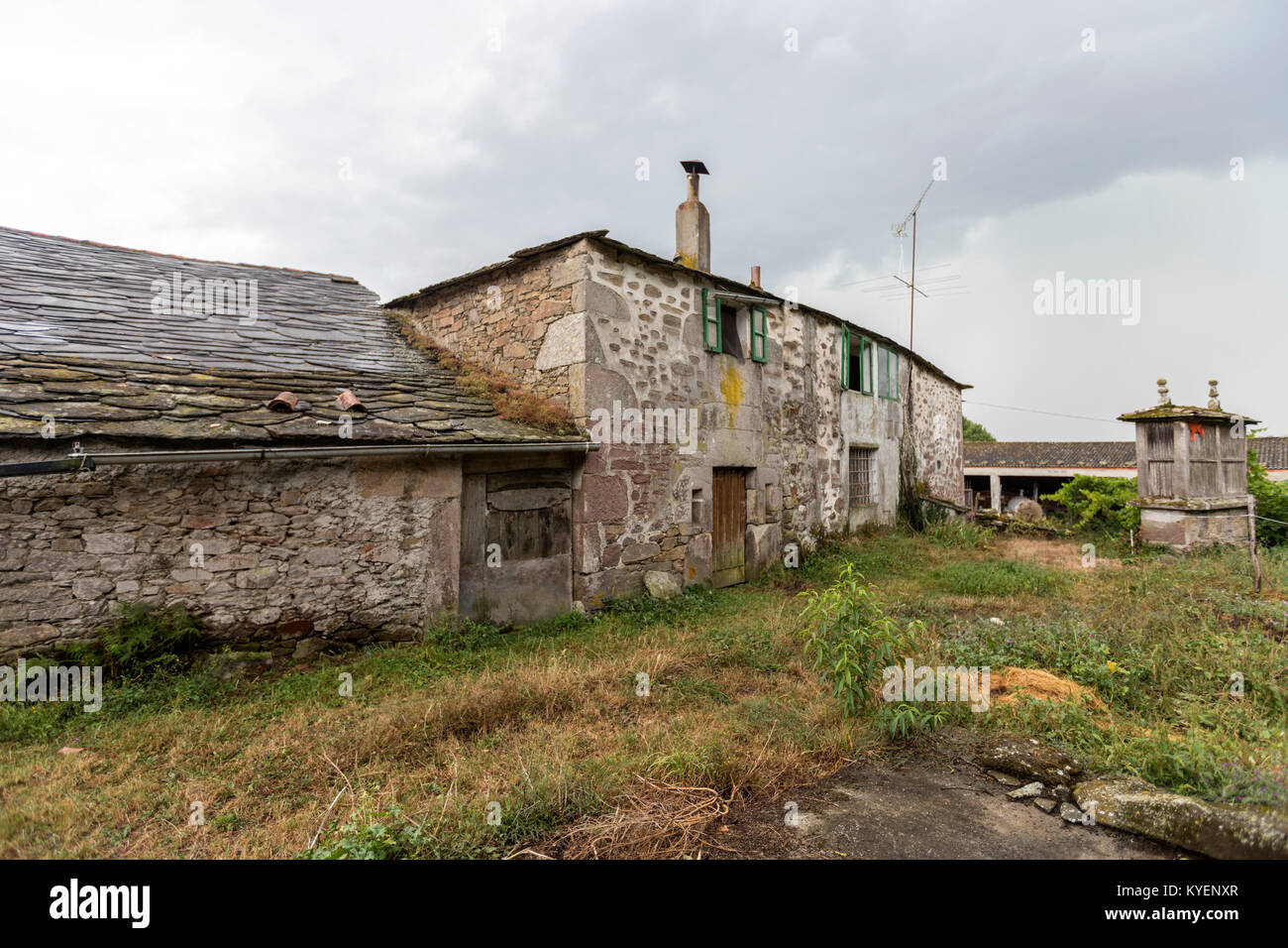 Typical stone rural house in Galicia with slate roof and horreo in Rios ...