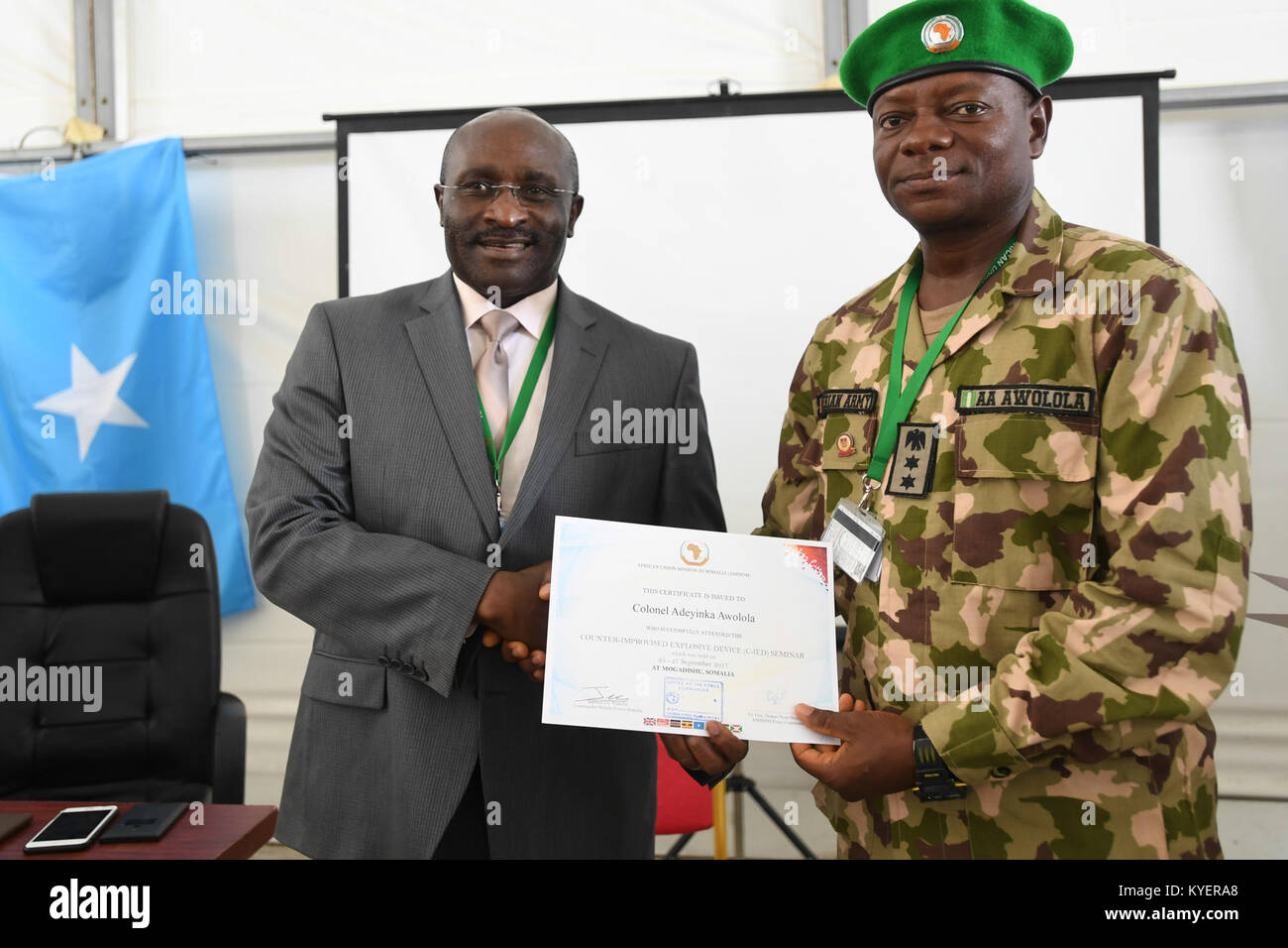 Simon Mulongo, Deputy SRCC for Somalia, presents a certificate to an ...