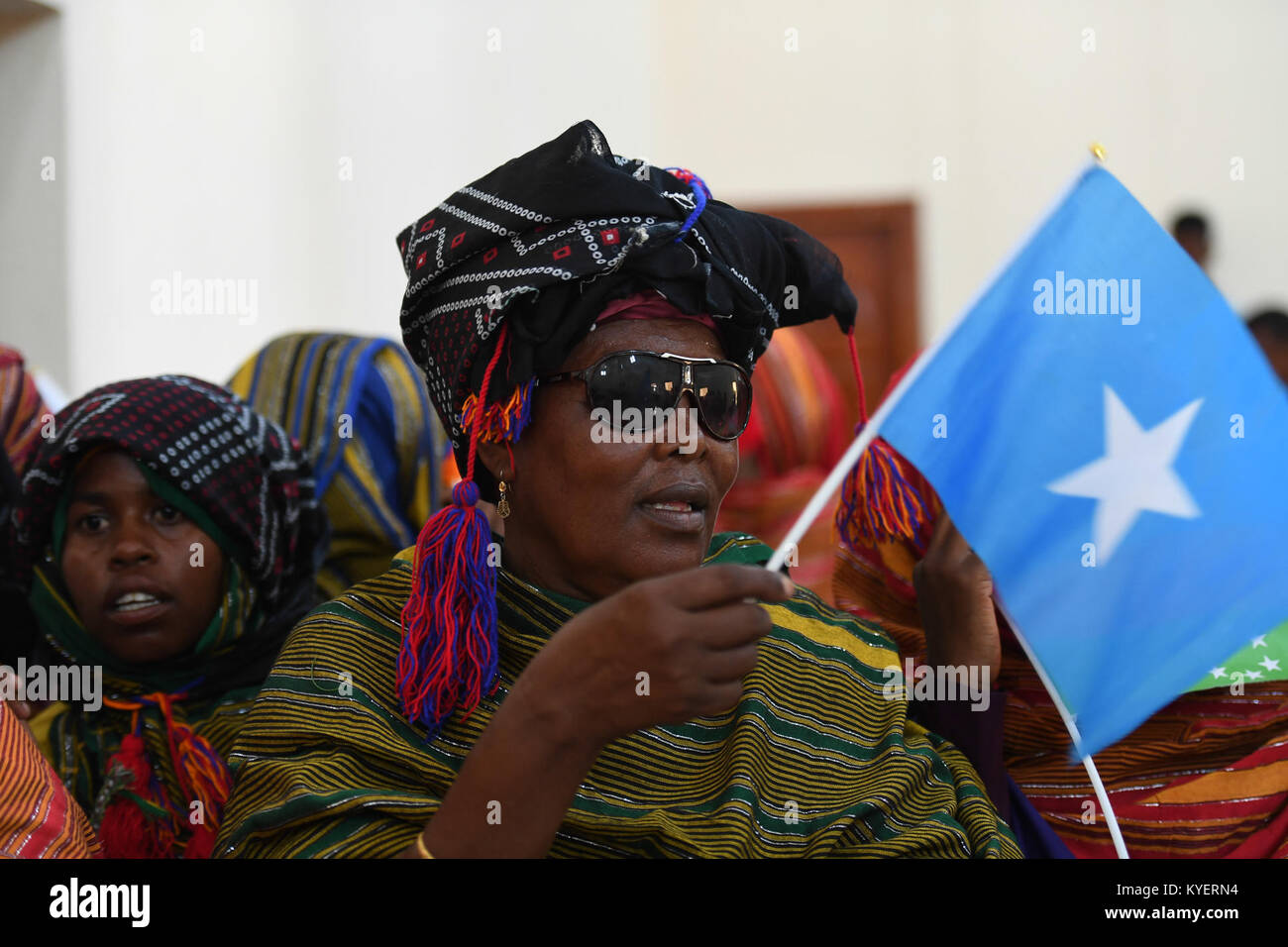 Photograph of women waving flags to welcome Ambassador Francisco ...