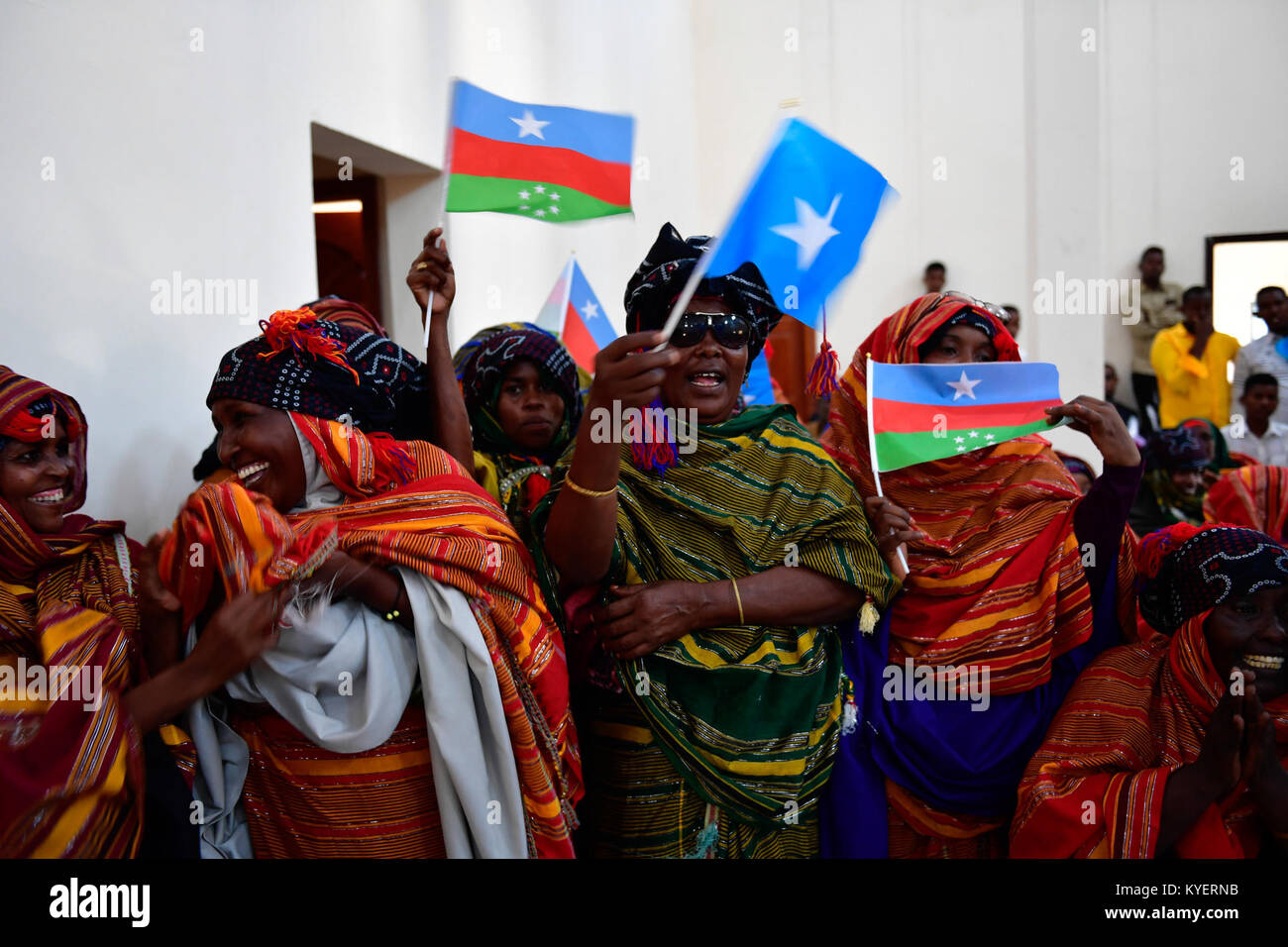Women wave flags to welcome the Special Representative of the ...